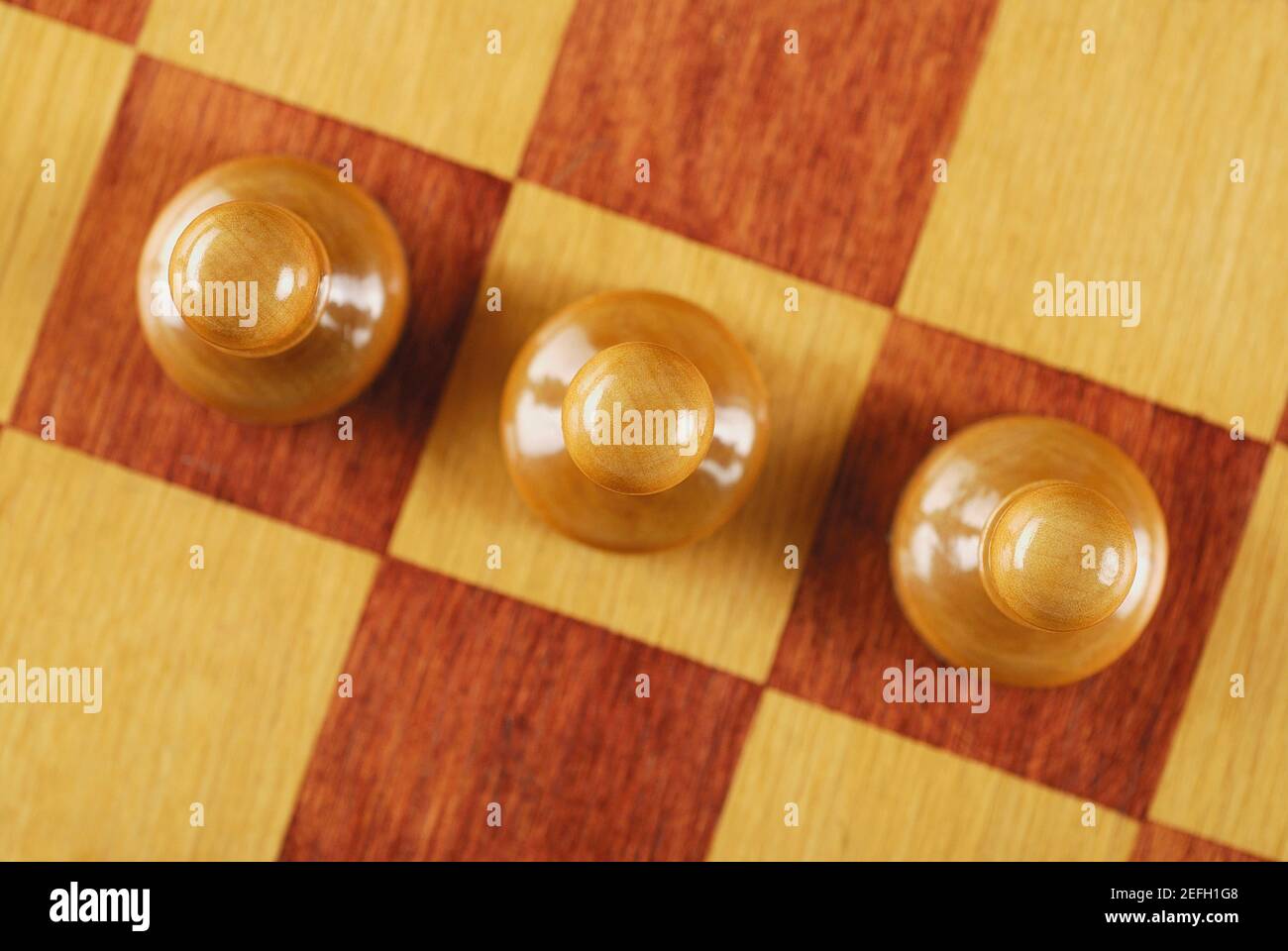 High angle view of three chess pieces on a chessboard Stock Photo - Alamy