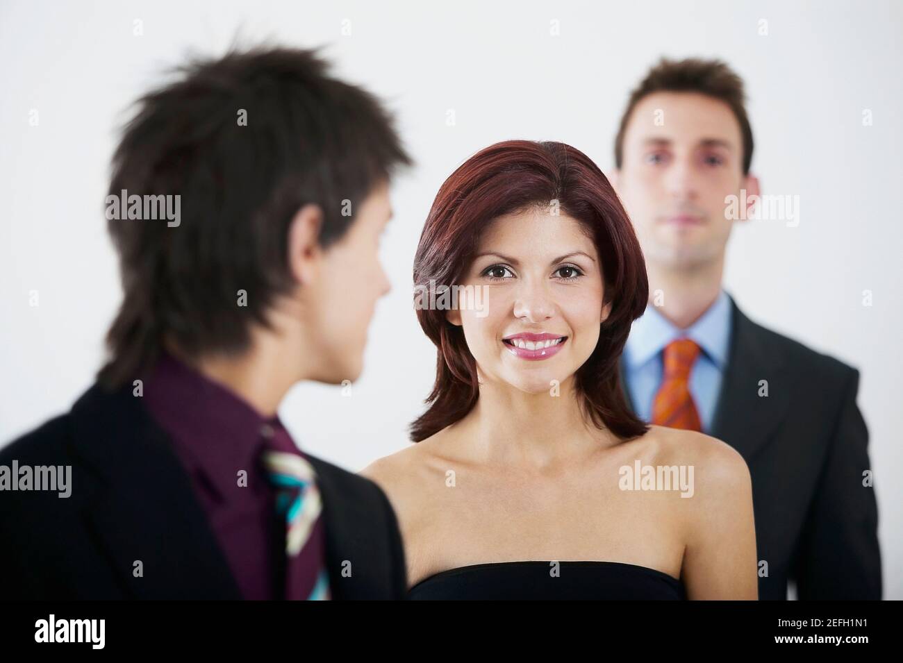 Three business executives standing in a row Stock Photo - Alamy