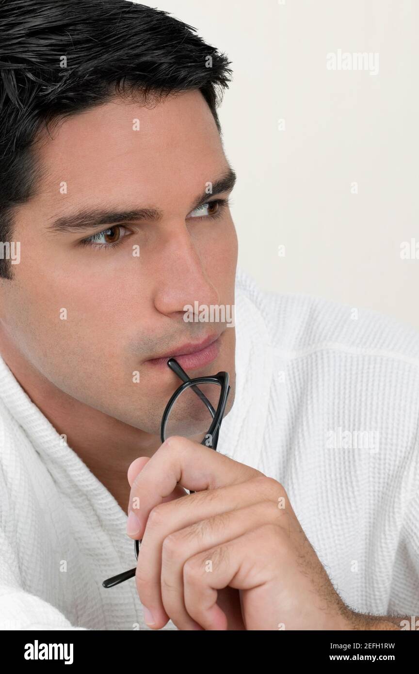Close-up of a young man thinking Stock Photo - Alamy