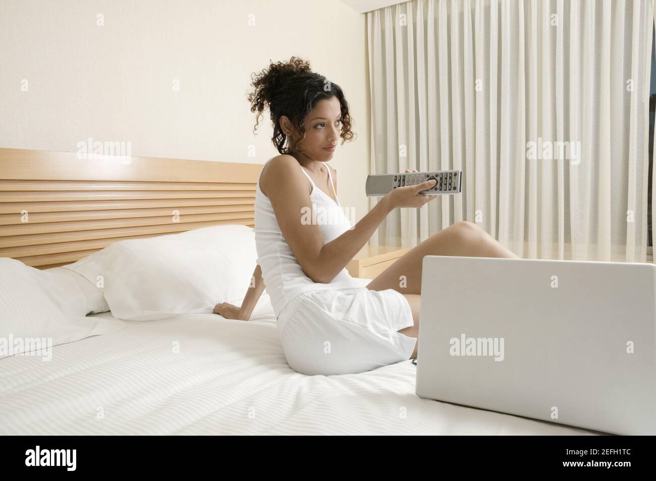 Side profile of a teenage girl using a remote control Stock Photo - Alamy