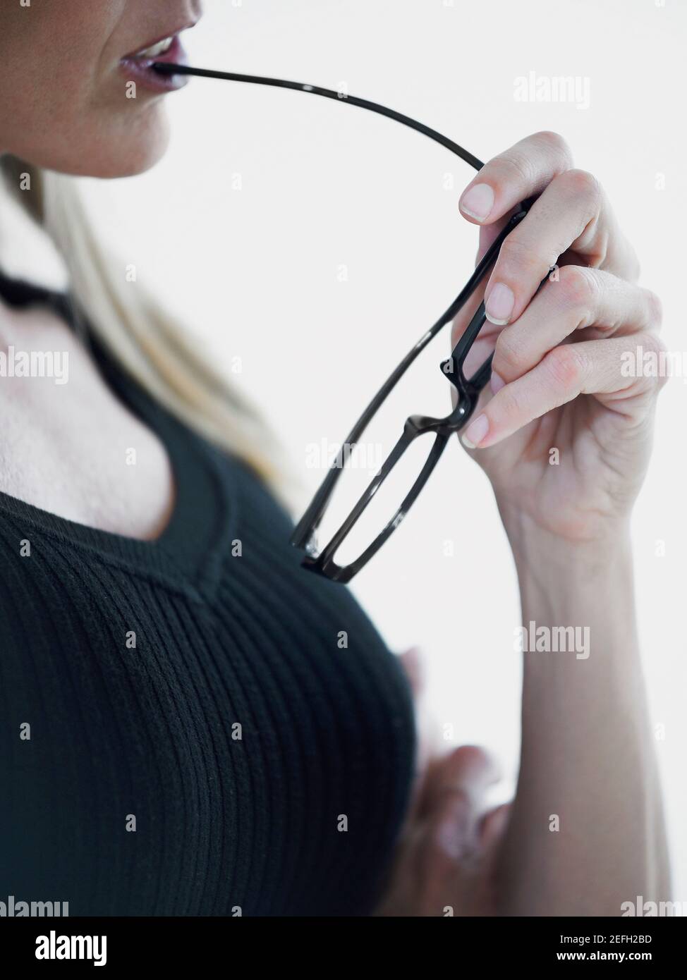 Woman biting eyeglasses hi-res stock photography and images - Alamy