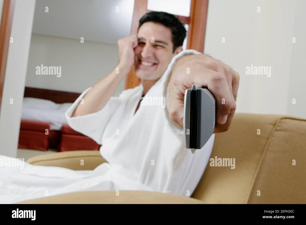 Side profile of a man holding a remote control hi-res stock photography ...