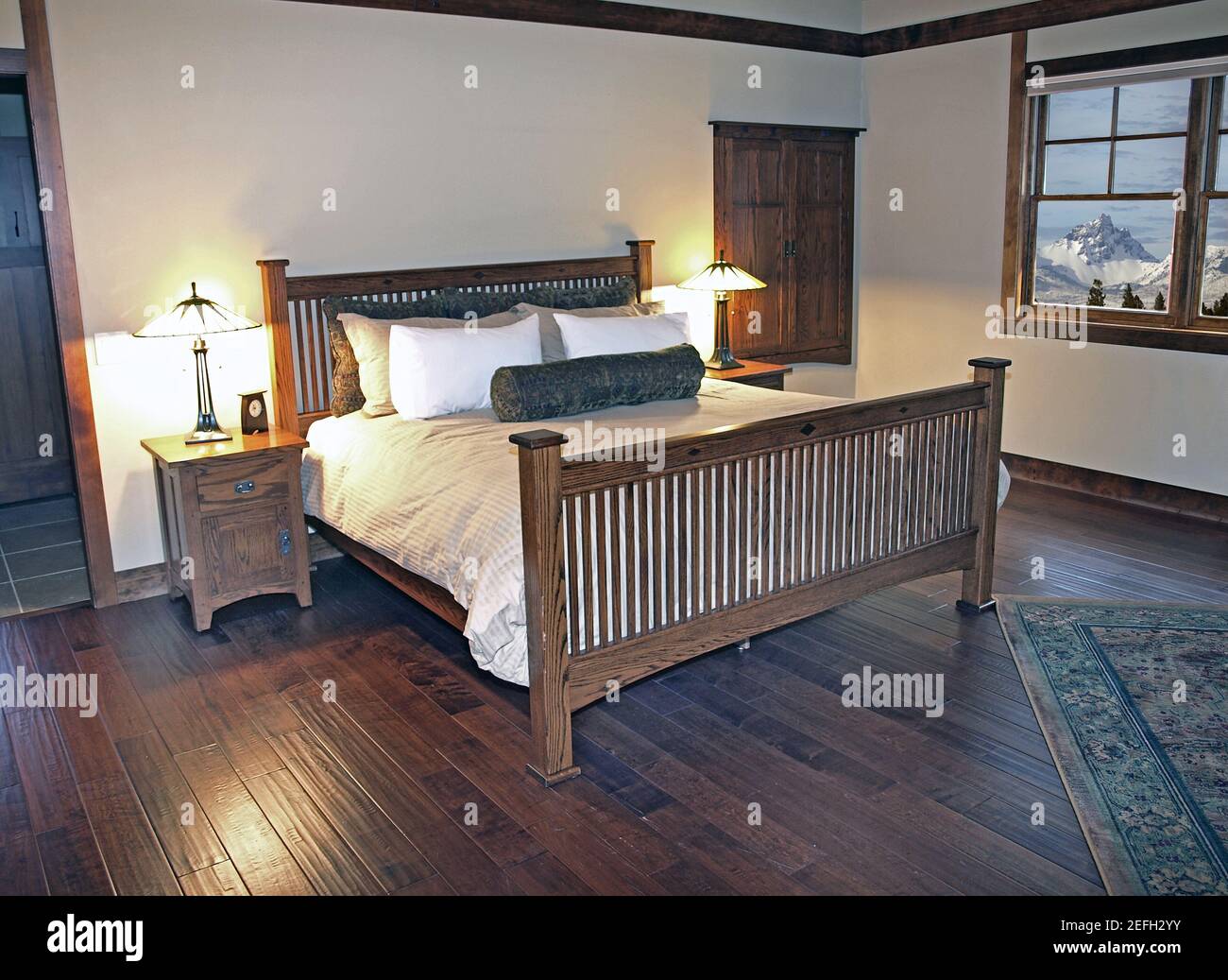 Portrait of a large, queen-sized bed in the bedroom of a home in the ...
