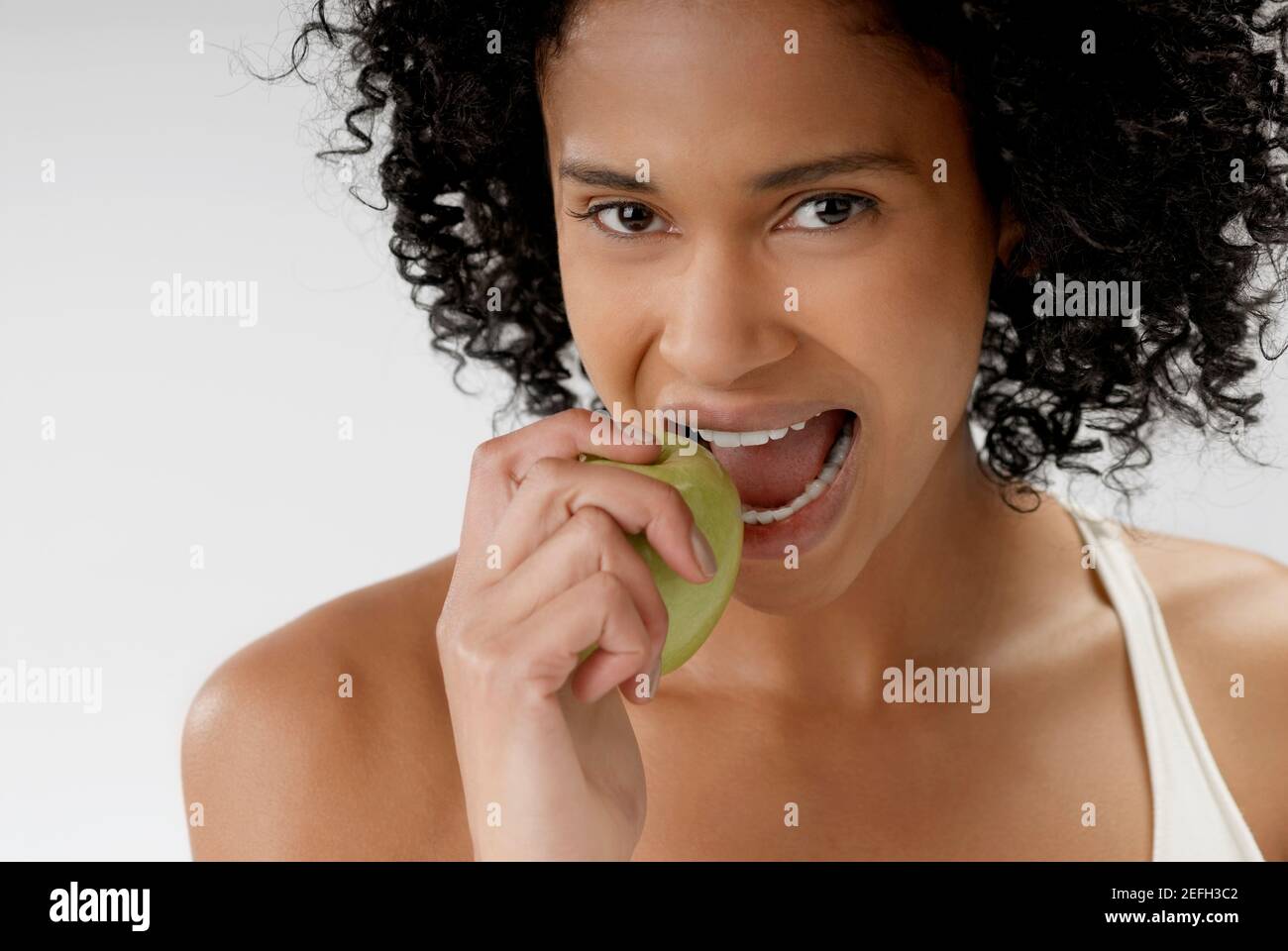 Portrait of a young woman eating an apple hi-res stock photography and ...
