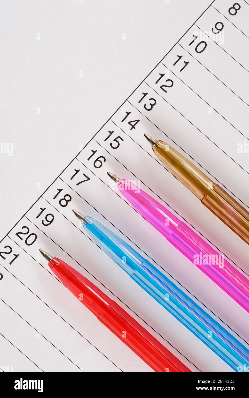 High angle view of four pens on a sheet of paper Stock Photo - Alamy