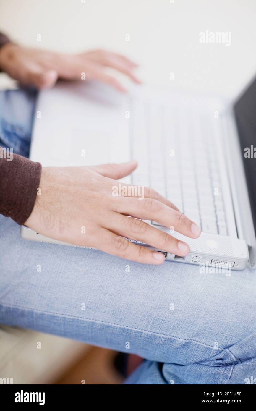 Mid section view of a man using a laptop Stock Photo - Alamy