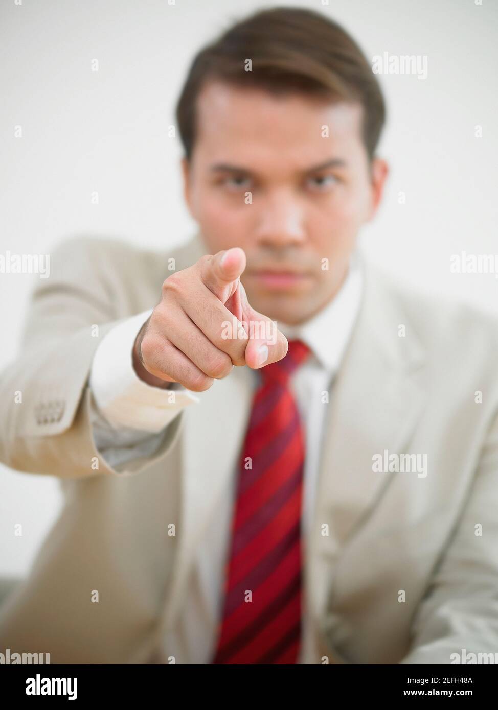 Portrait of a businessman pointing forward Stock Photo - Alamy