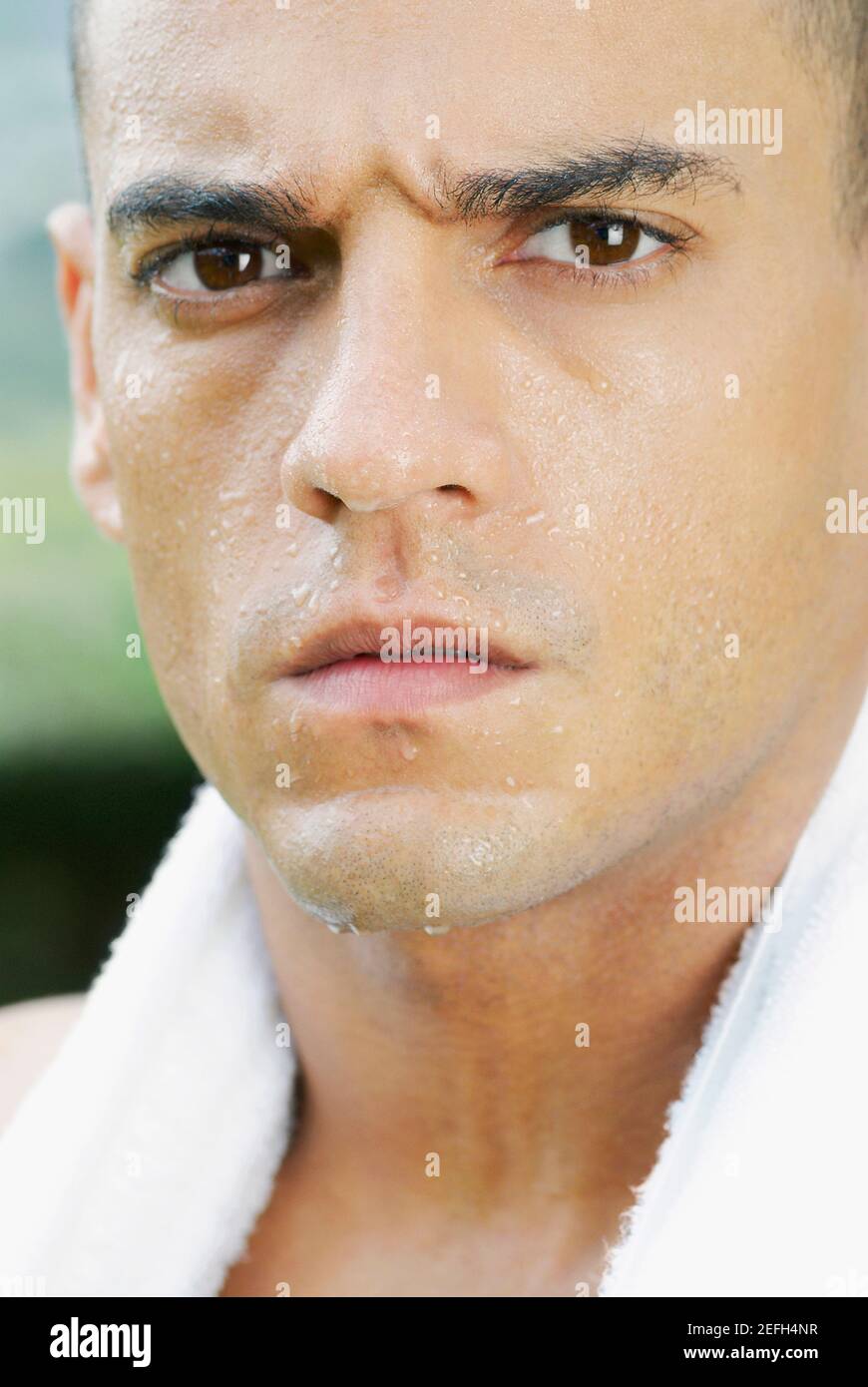 Portrait of a young man looking angry Stock Photo - Alamy