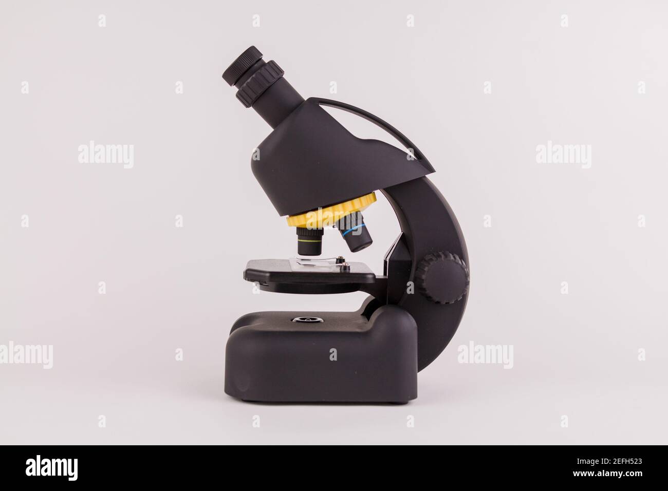 a black microscope on a white background to study the microworld Stock ...