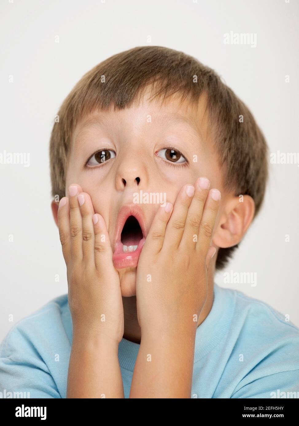 Portrait of a boy stretching his cheeks Stock Photo - Alamy