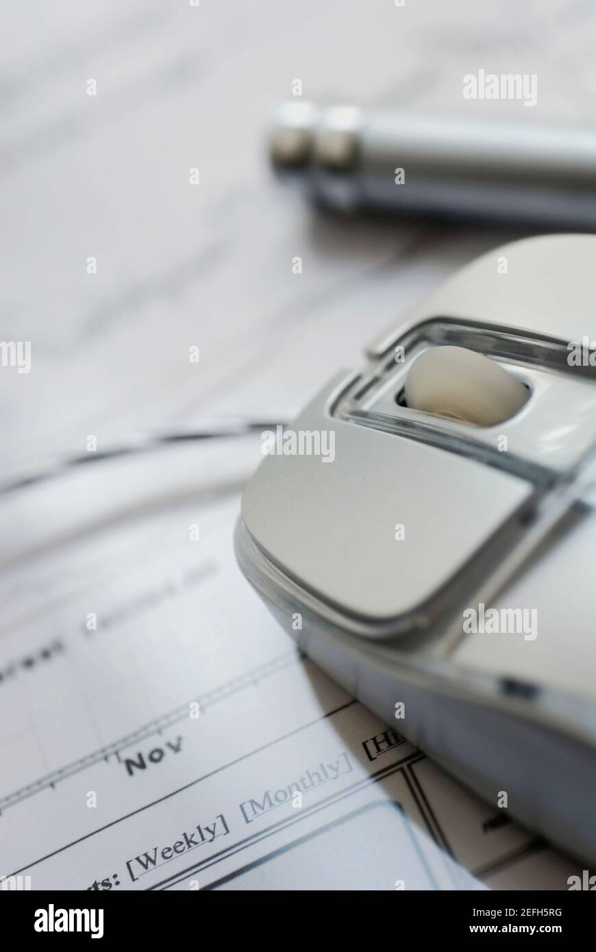 Close up of a computer mouse and a pen on a sheet of paper Stock Photo ...