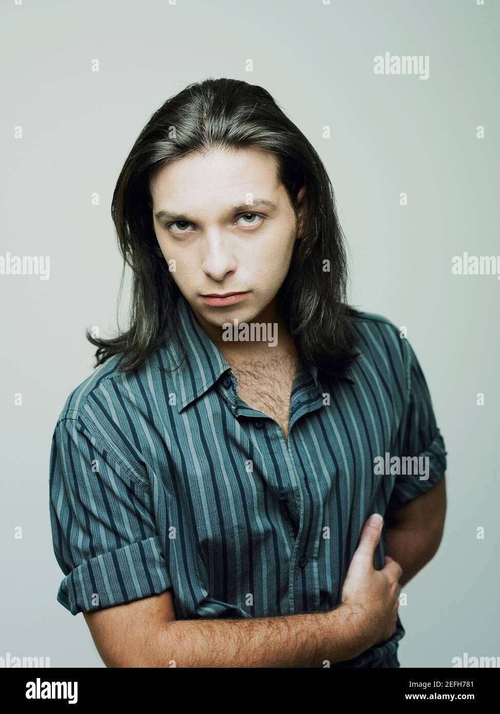 Contemplative young hispanic man standing hi-res stock photography and ...