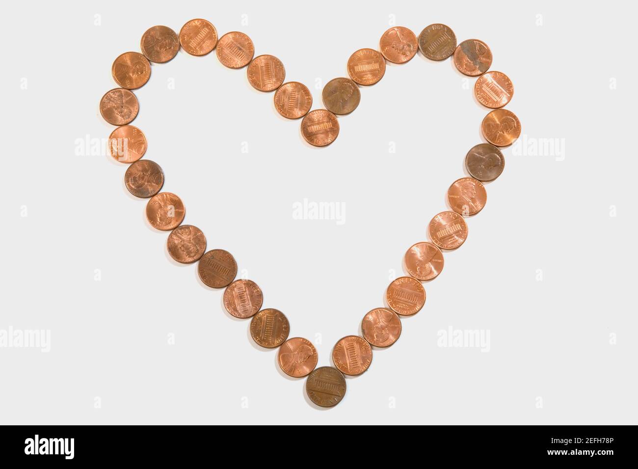 Coins arranged in a heart shape Stock Photo - Alamy