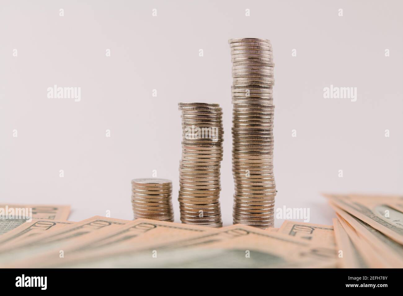 a money coins in columns with dollar bills on a white background Stock ...