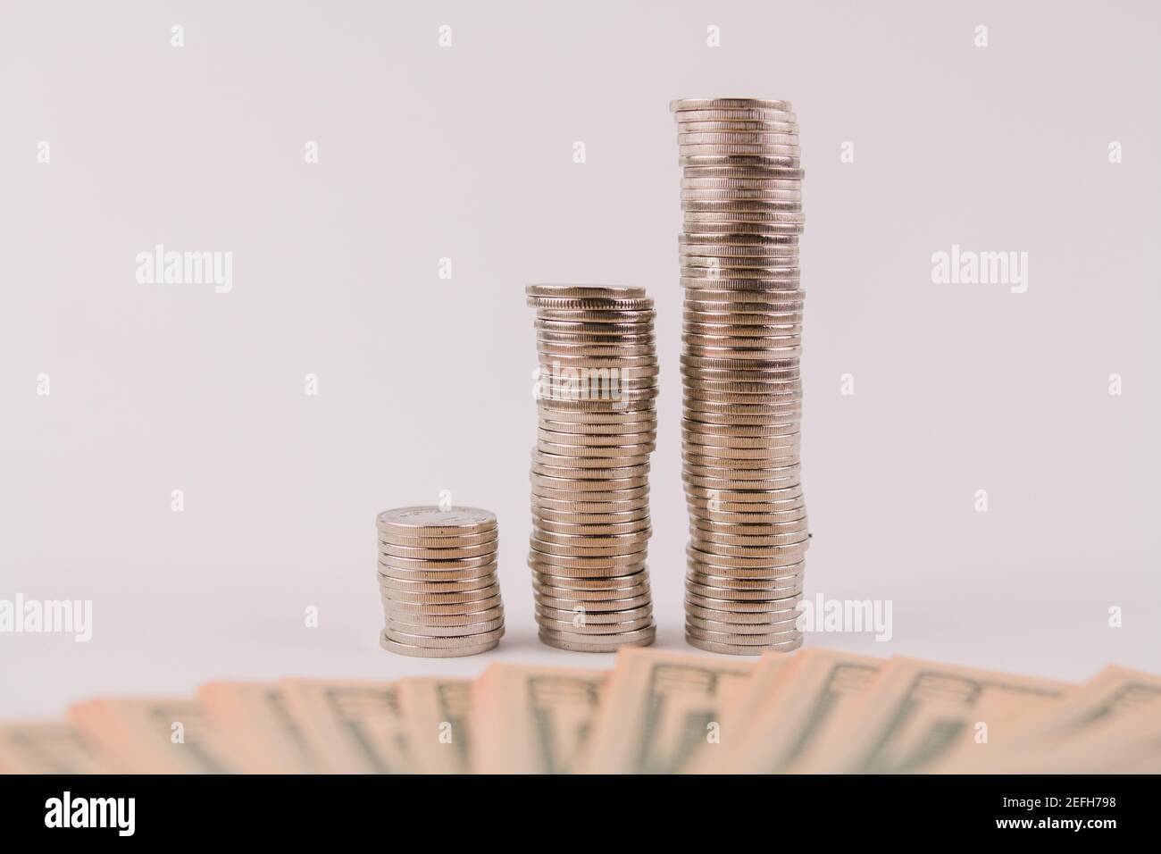 a money coins in columns with dollar bills on a white background Stock ...