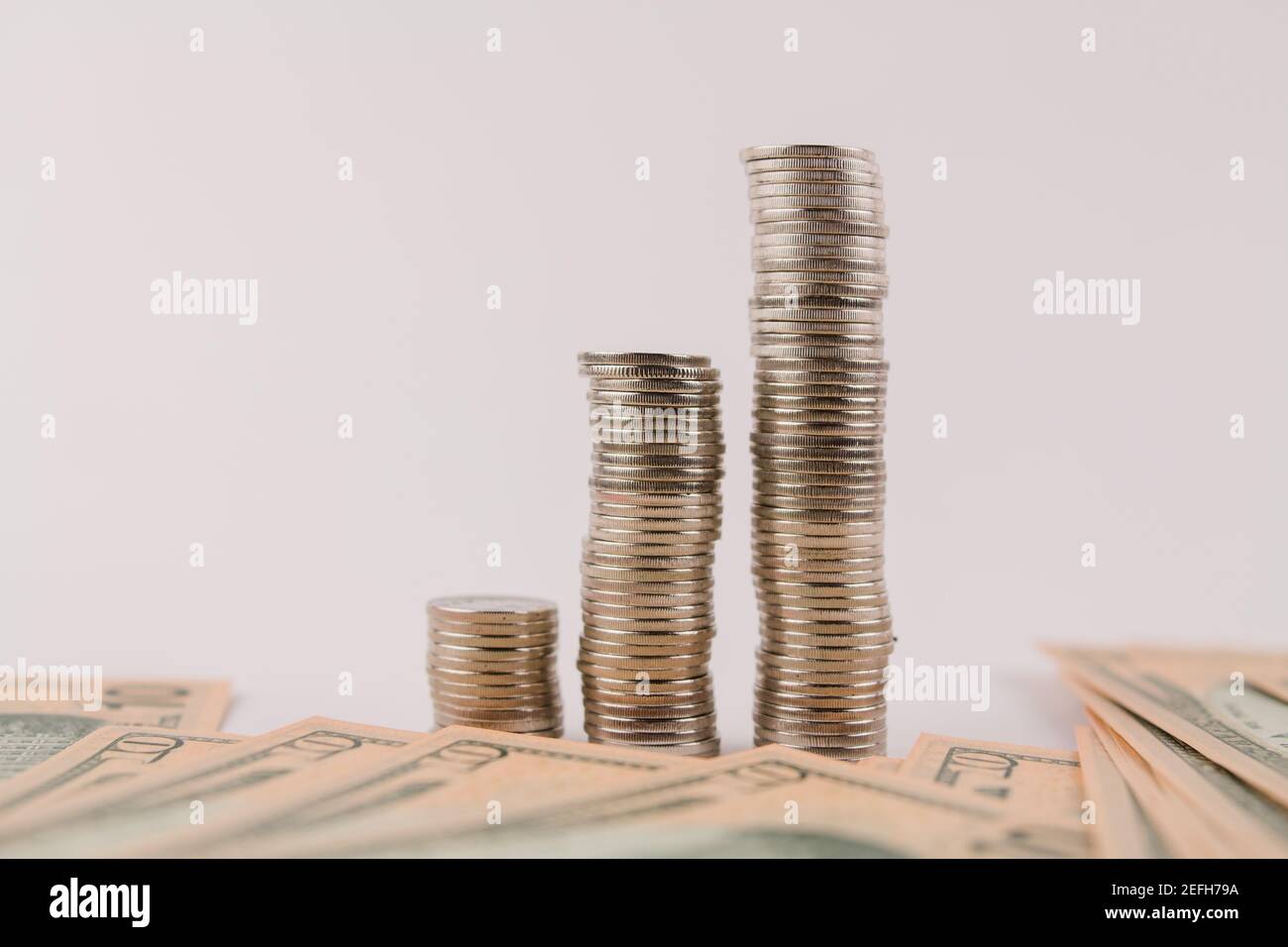 a money coins in columns with dollar bills on a white background Stock ...