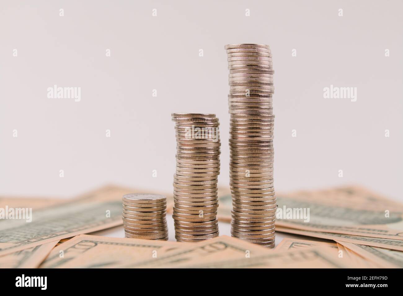 a money coins in columns with dollar bills on a white background Stock ...