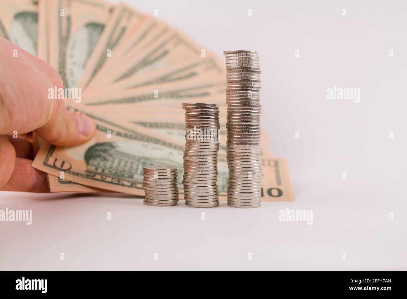 a money coins in columns with dollar bills on a white background Stock ...
