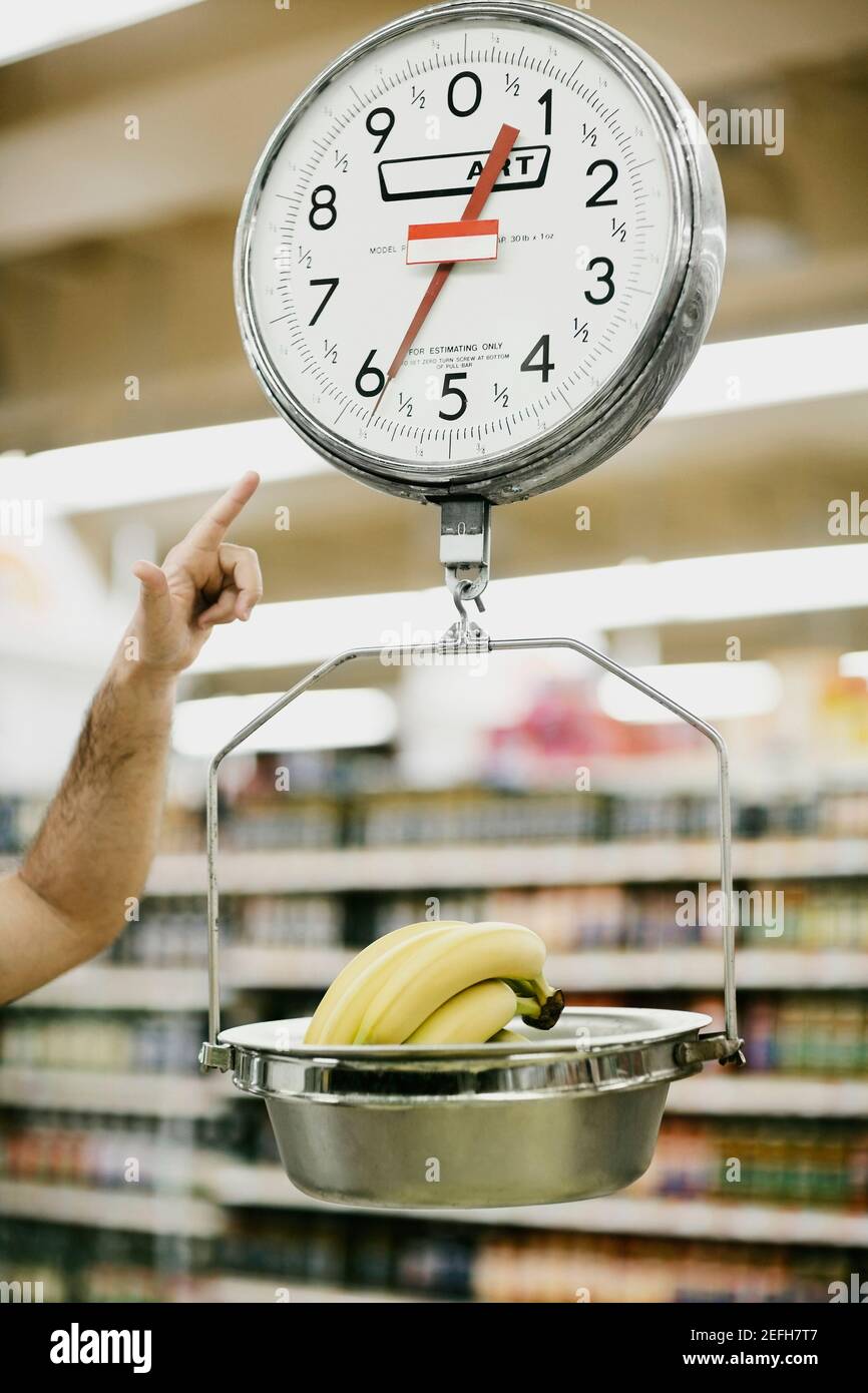 Close up of a personŽs hand pointing towards a weighing scale Stock ...