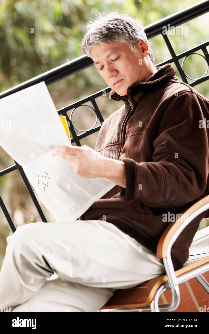 Side profile of a senior man reading a newspaper Stock Photo - Alamy