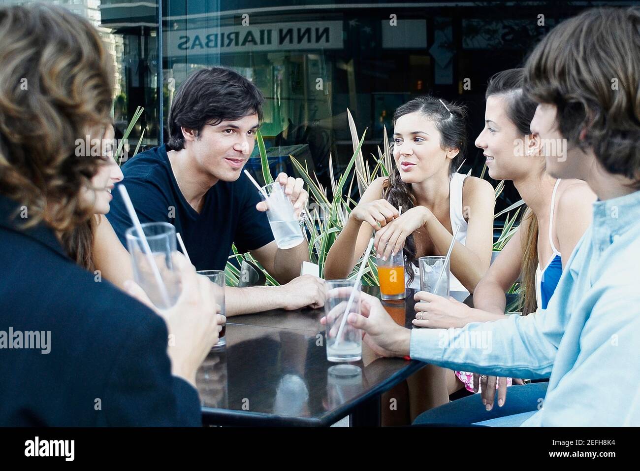 Group of people sitting together hi-res stock photography and images ...