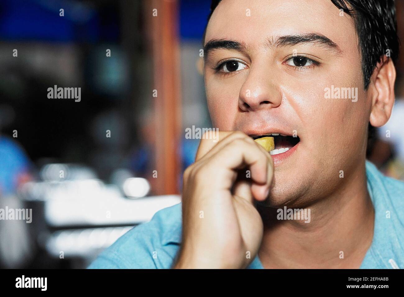 Close up of a young man eating French fries Stock Photo - Alamy