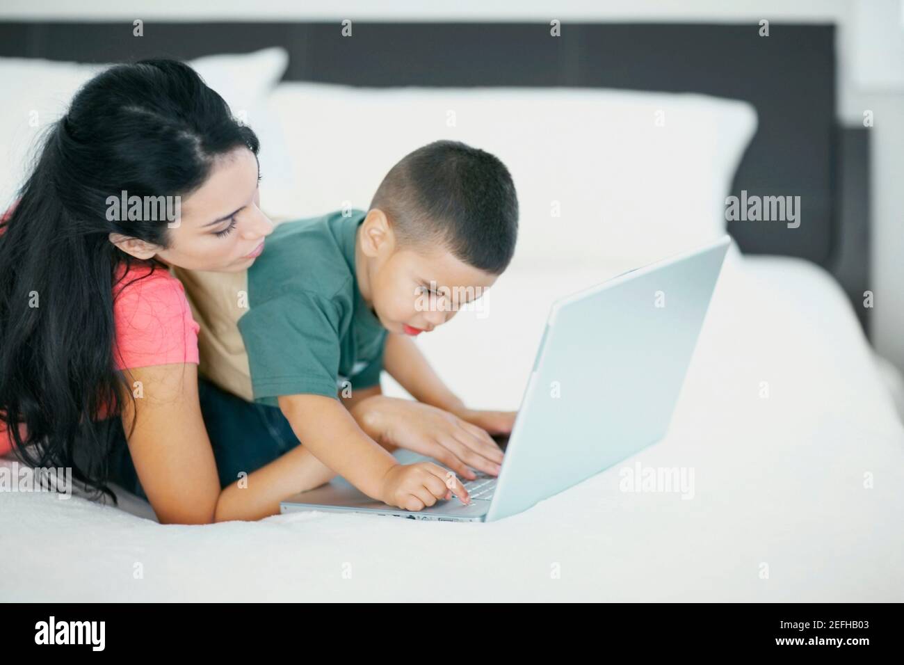 Side profile of a boy and his mother using a laptop Stock Photo - Alamy
