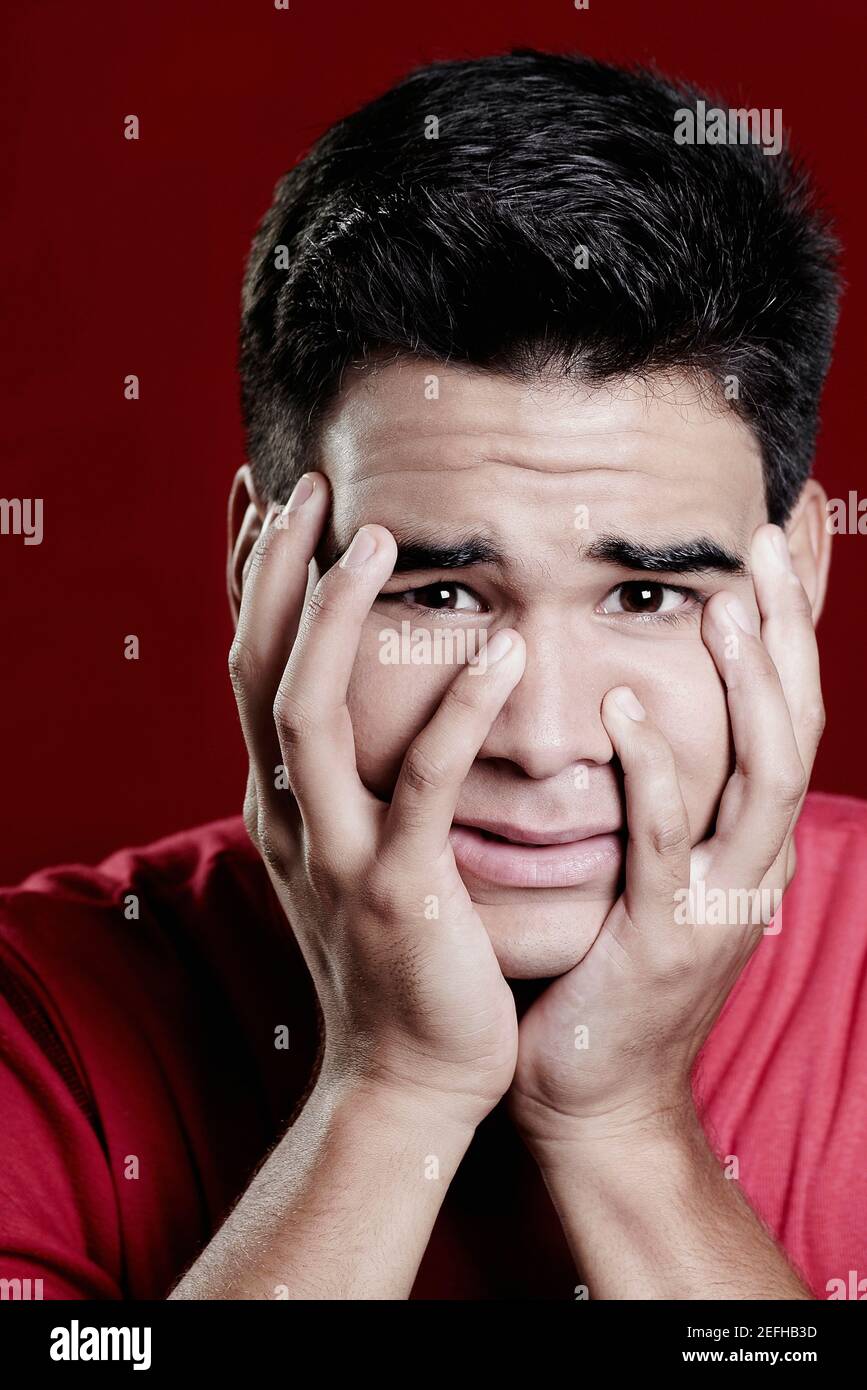 Portrait of a young man looking worried Stock Photo - Alamy