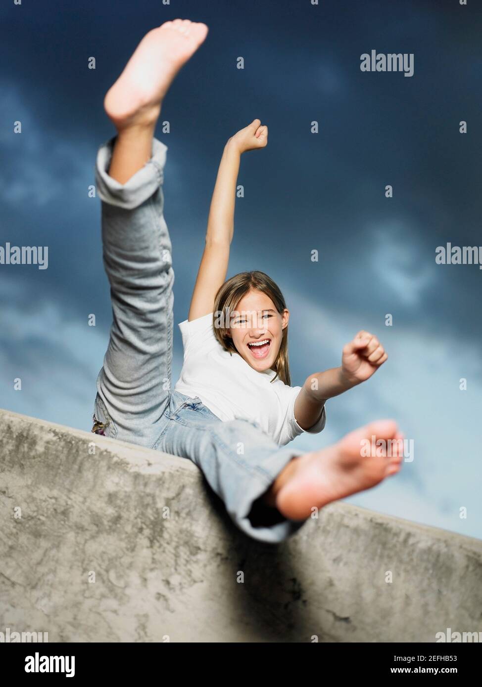 Low angle view of a teenage girl shouting with her arms outstretched ...