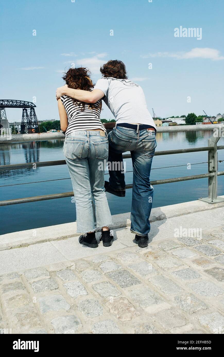 Happy young couple leaning on bridge railing hi-res stock photography ...