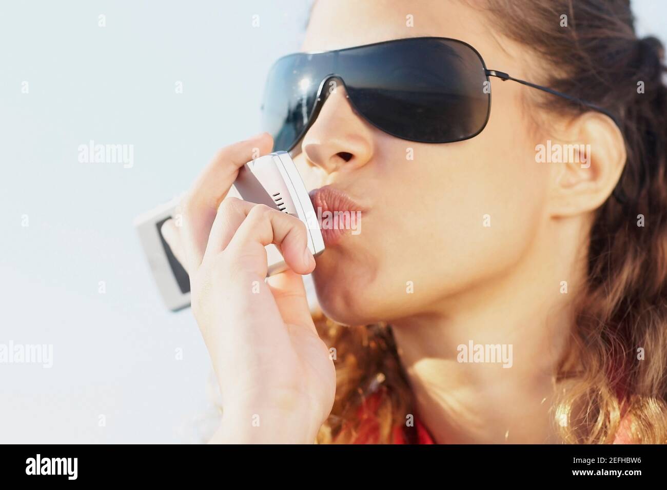 Woman kissing mobile phone hi-res stock photography and images - Alamy