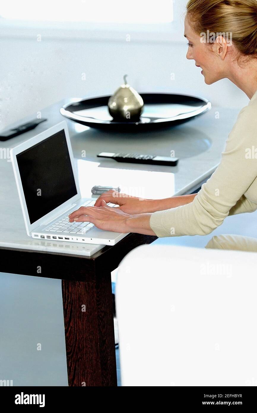 Side profile of a young woman using a laptop Stock Photo - Alamy