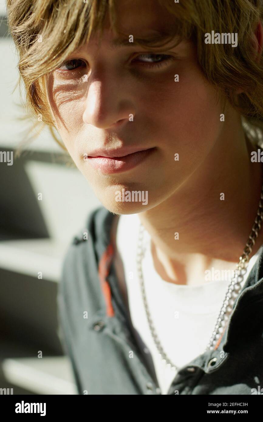 Close up of a teenage boy looking sideways Stock Photo - Alamy