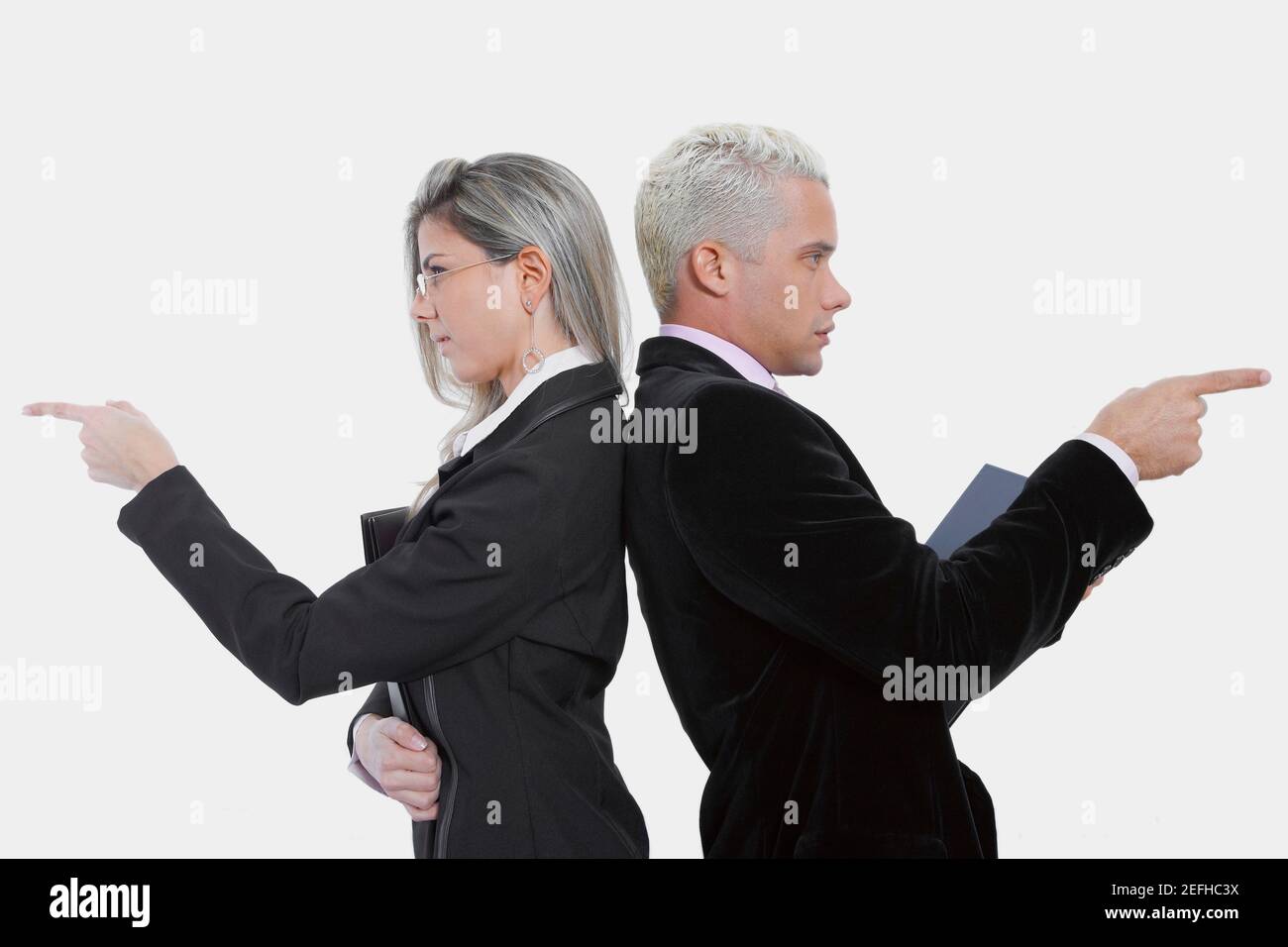 Side profile of a businessman and a businesswoman standing back to back ...