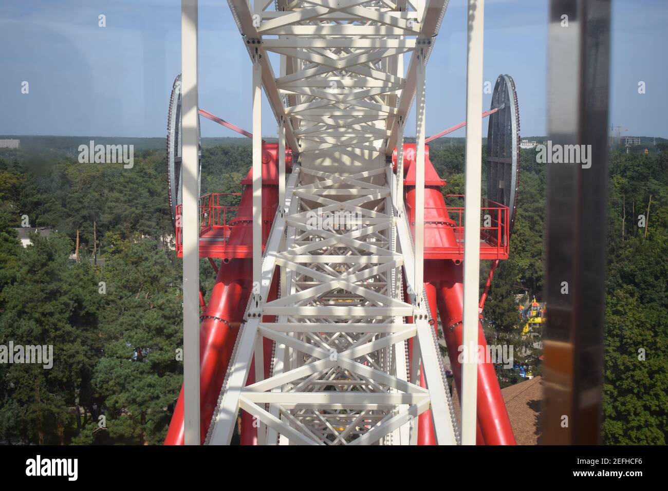 Ferris wheel construction seen from one of the cabins. Part of a white ...
