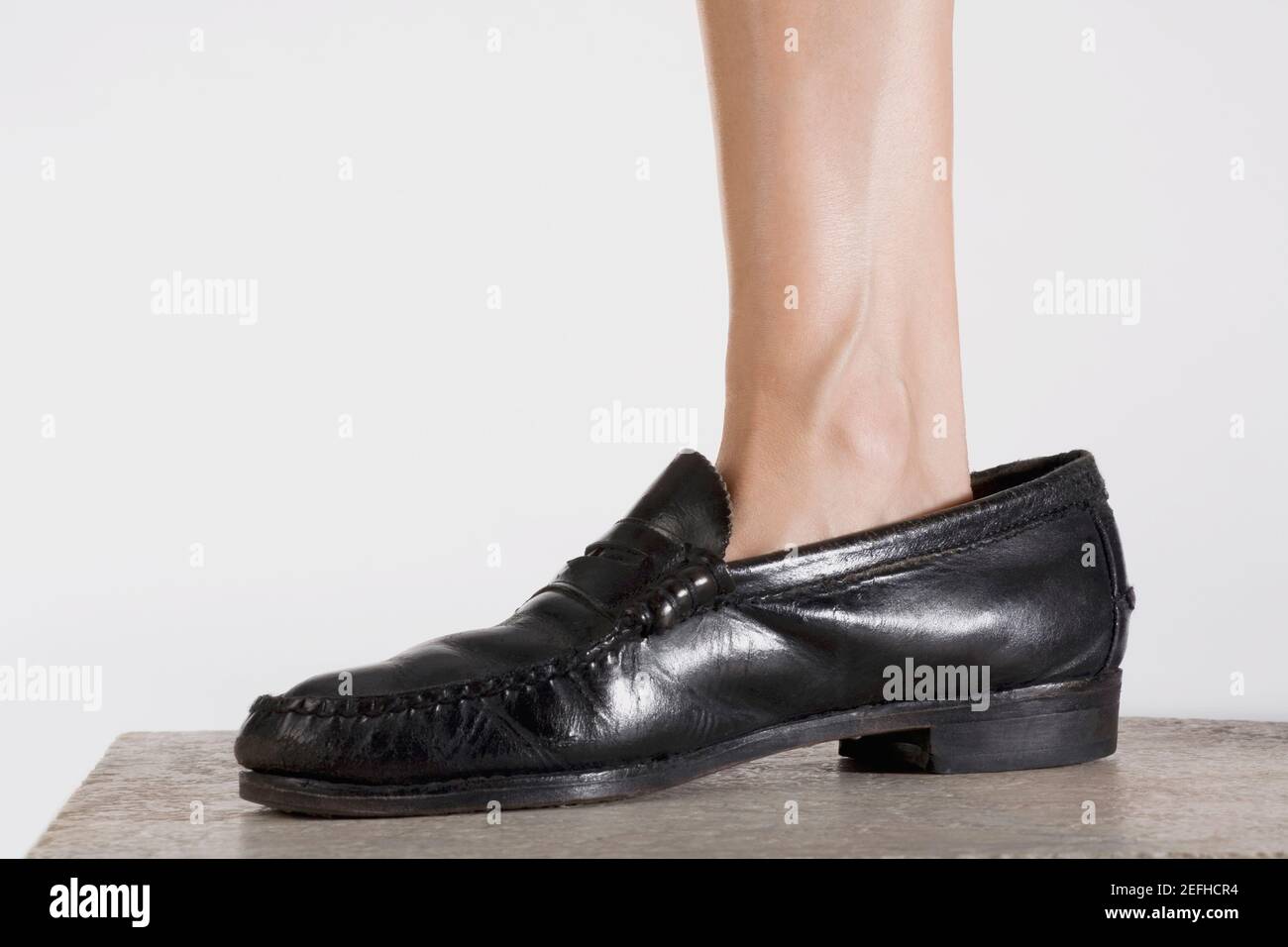 Low section view of a person wearing a shoe Stock Photo - Alamy