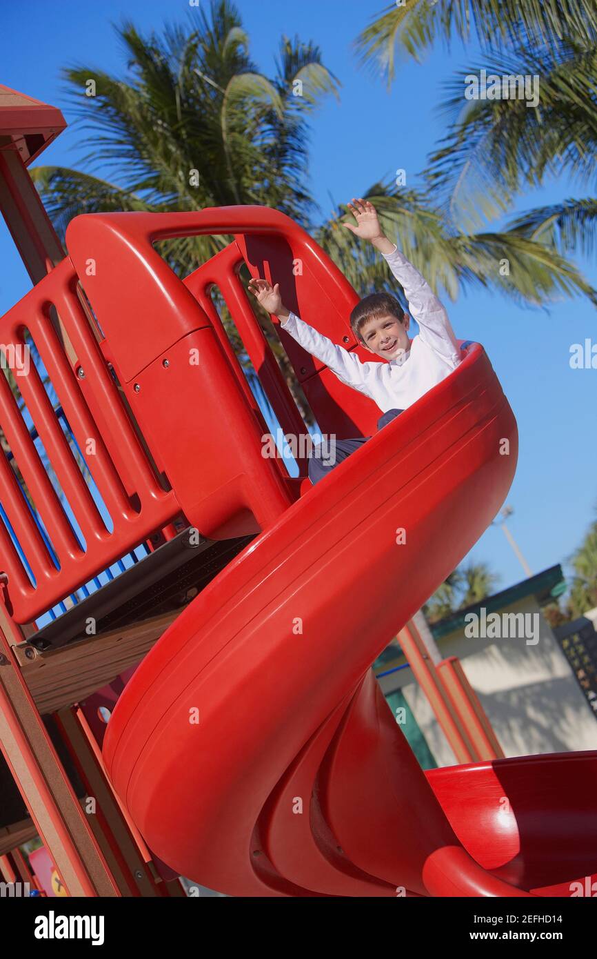 Boy sliding down a slide Stock Photo - Alamy