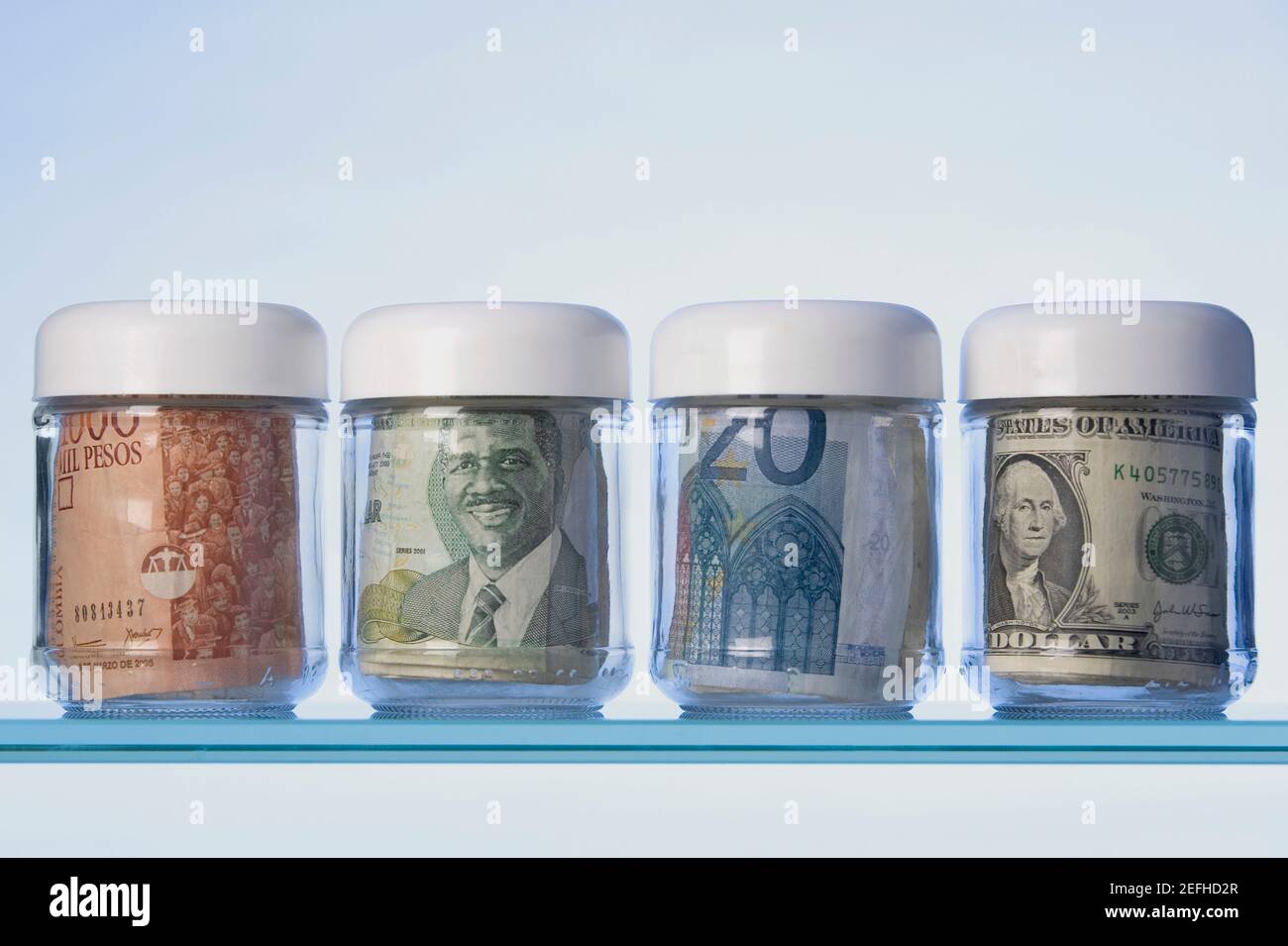 Paper currency in jars Stock Photo - Alamy