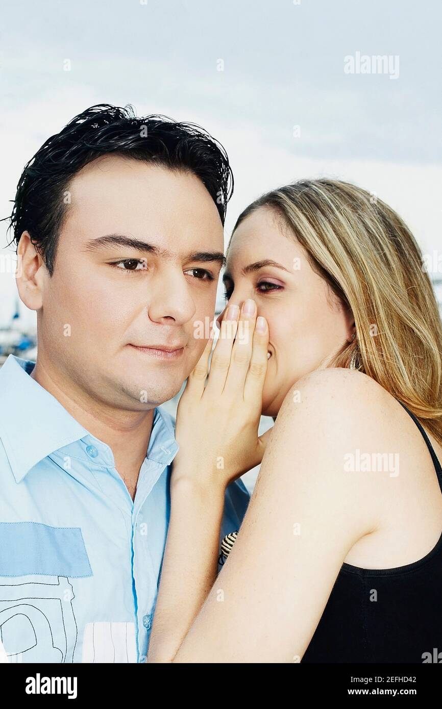 Adults whispering into ear hi-res stock photography and images - Alamy