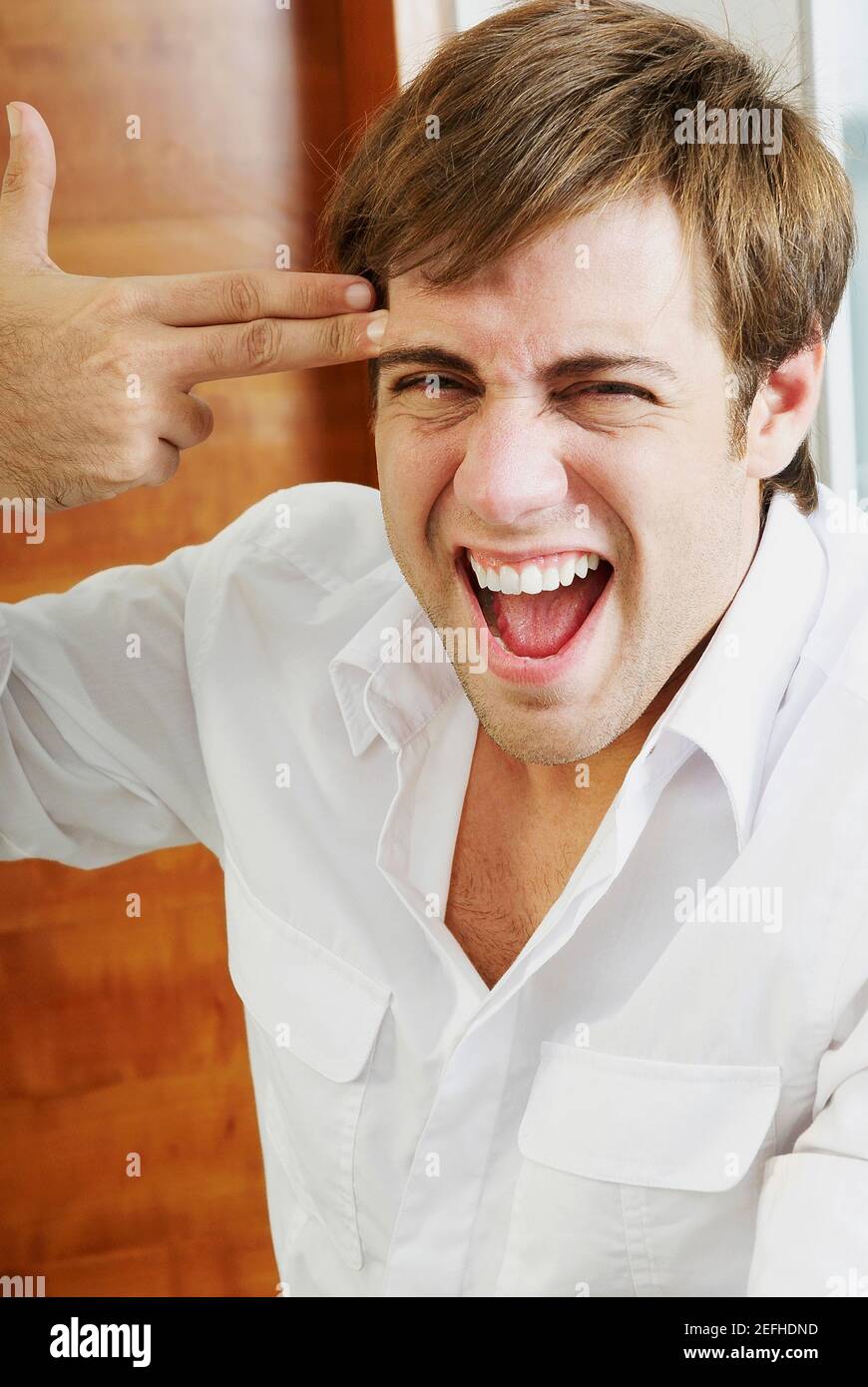 Man making finger gun gesture hi-res stock photography and images - Alamy