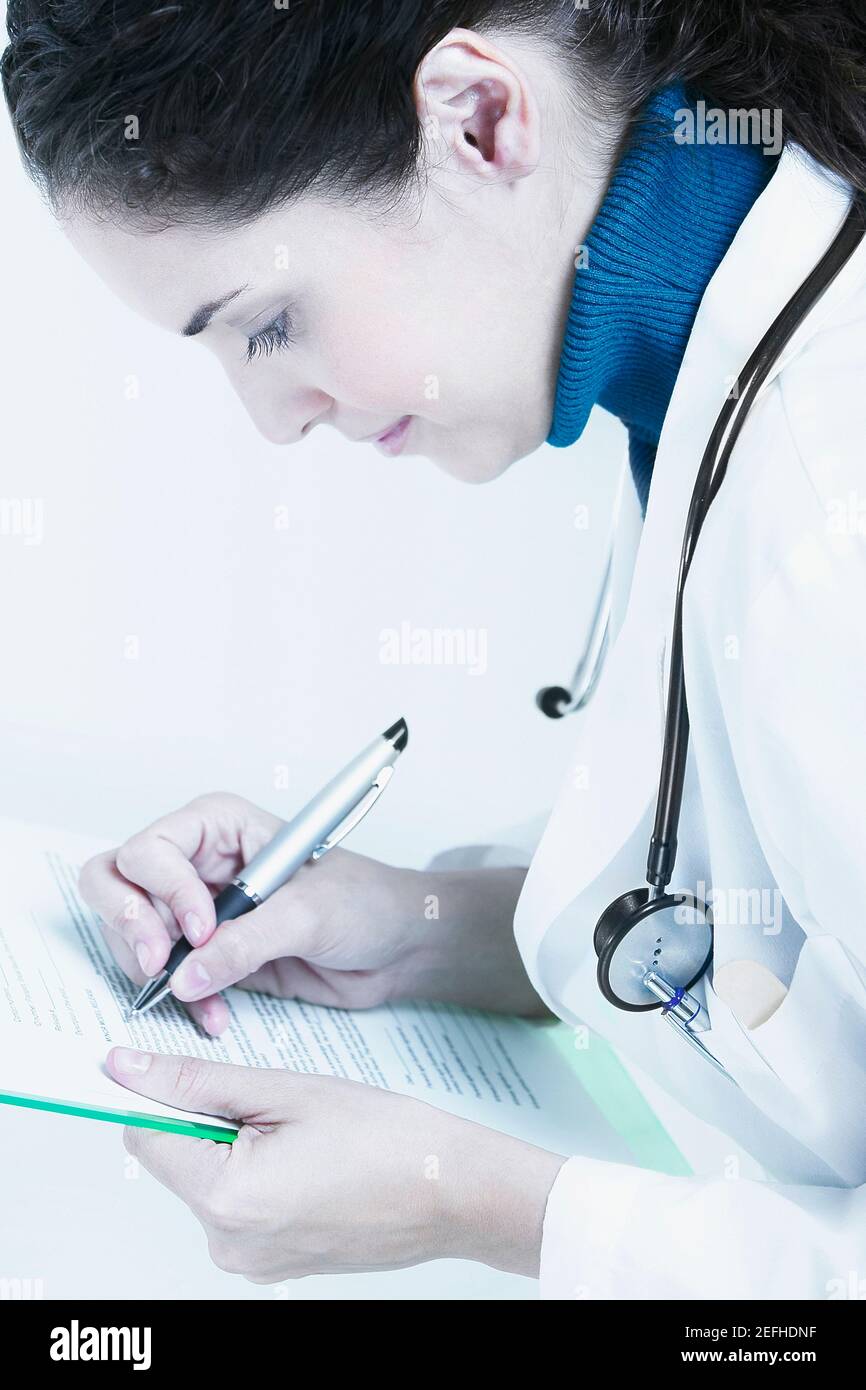 Female doctor clipboard pen writing hi-res stock photography and images ...