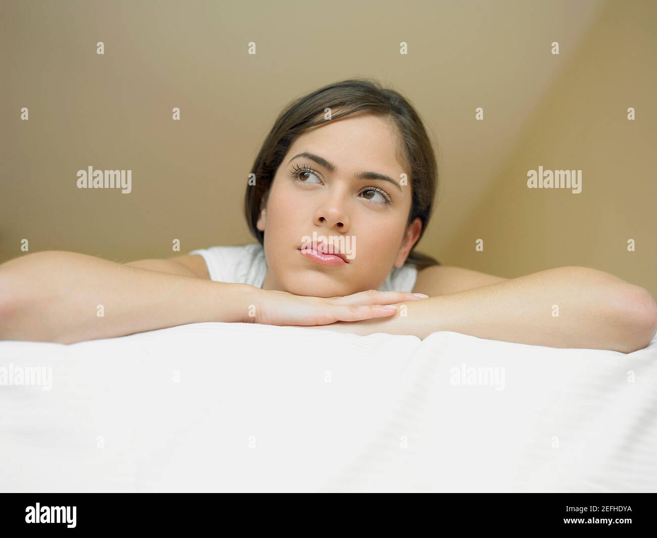 Low angle view of a young woman lying on the bed and thinking Stock ...