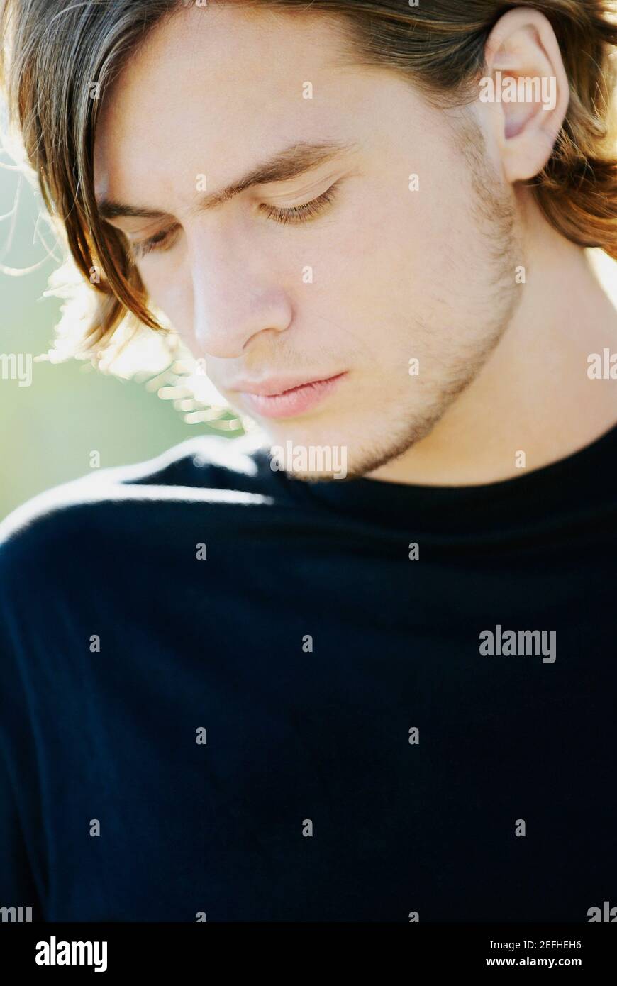 Close up of a teenage boy thinking Stock Photo - Alamy