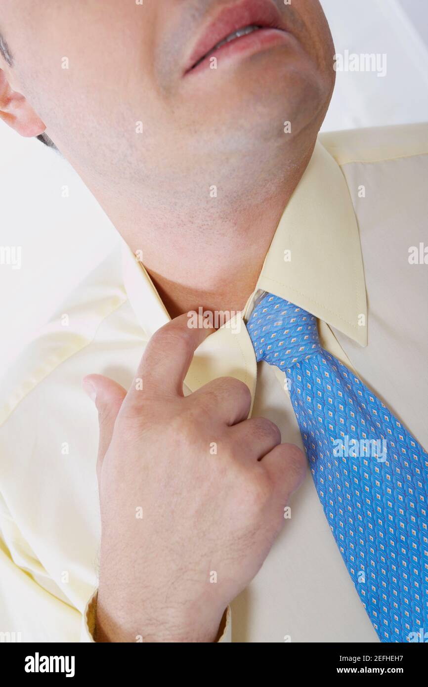 Businessman pulling collar hi-res stock photography and images - Alamy