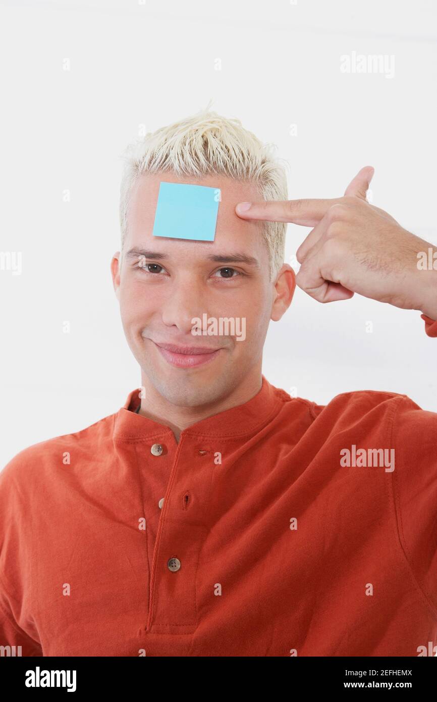 Portrait of a young man with an adhesive note on his forehead Stock ...