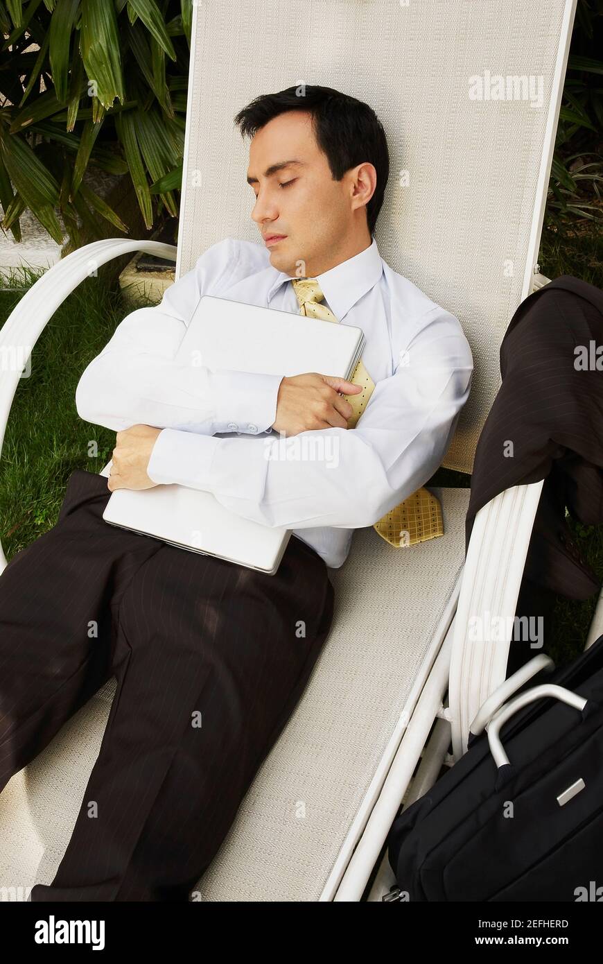 Businessman sleeping on a lounge chair Stock Photo - Alamy