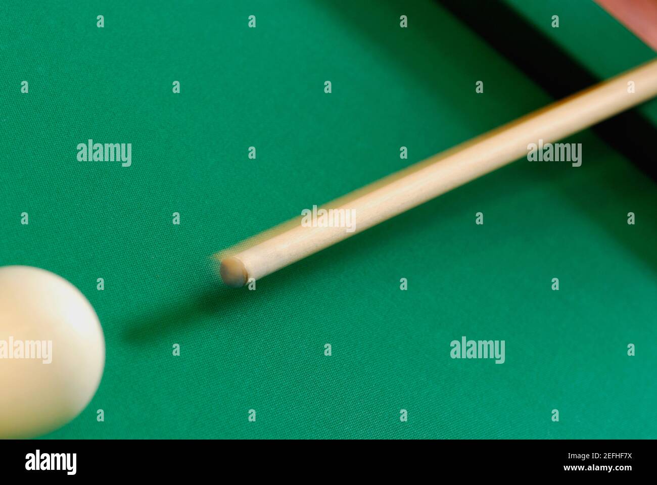 Close up of a pool cue hitting a pool ball Stock Photo - Alamy
