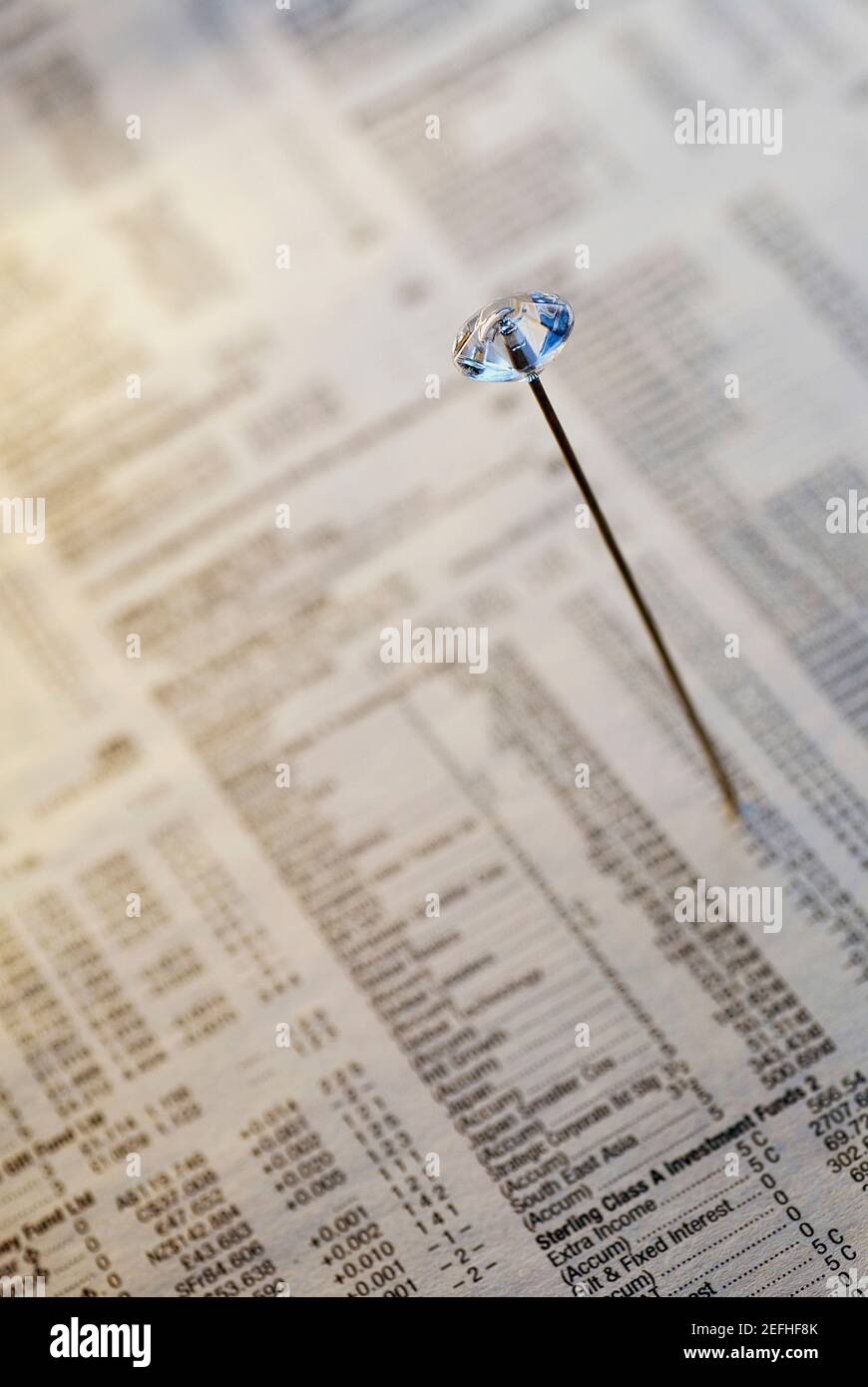 Close up of a straight pin on a financial newspaper Stock Photo - Alamy