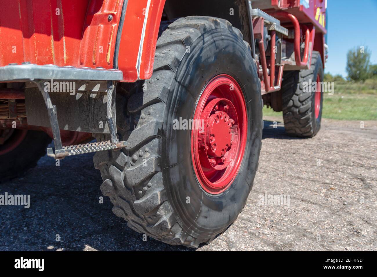 Closeup shot of the tires of a 4x4 fire truck in an open field during ...