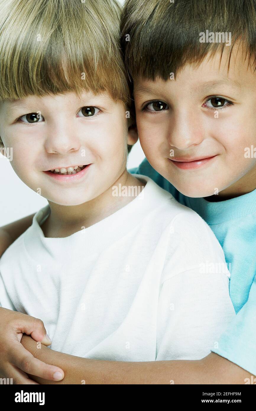 Portrait of a boy hugging his brother from behind Stock Photo - Alamy